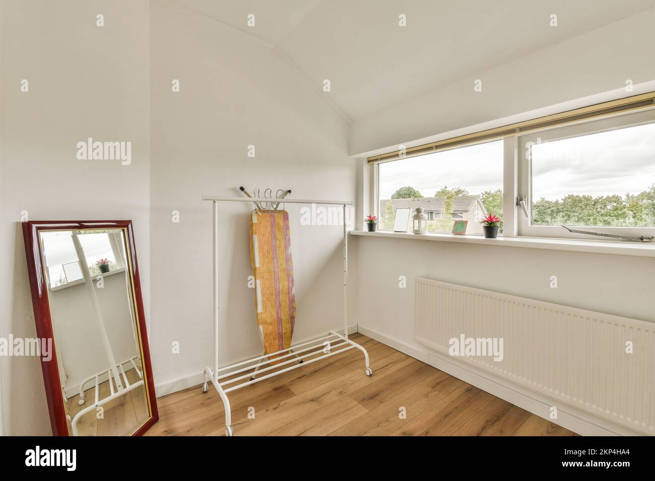 Comfortable bed located near window with curtain in light bedroom with ...