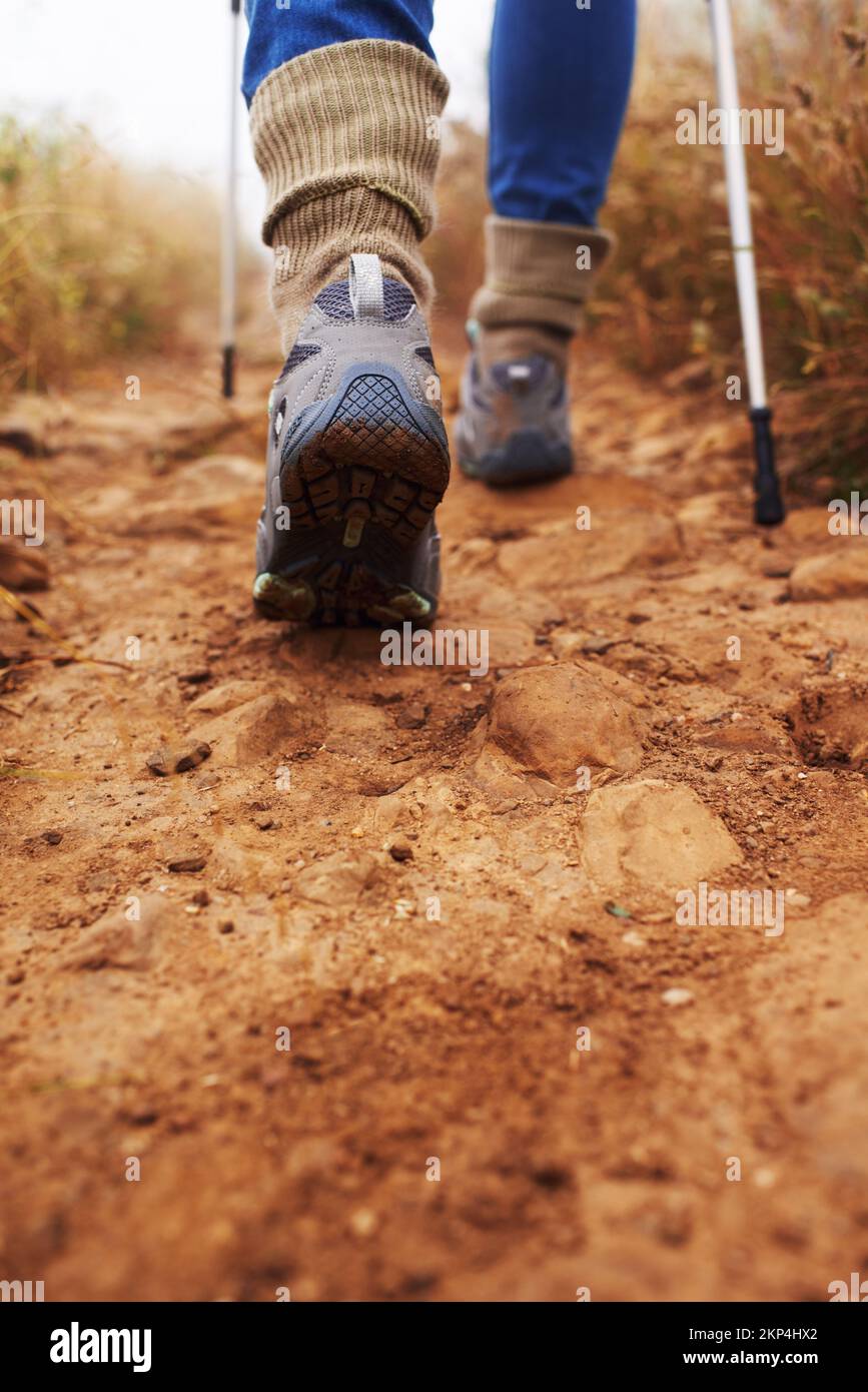 Tread carefully...Cropped rear view of a hiker walking along a trail ...