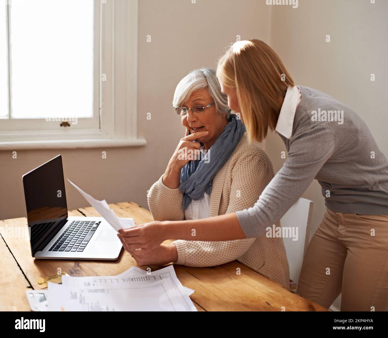 Taking some time to help her grandmother. Cropped view of a senior ...
