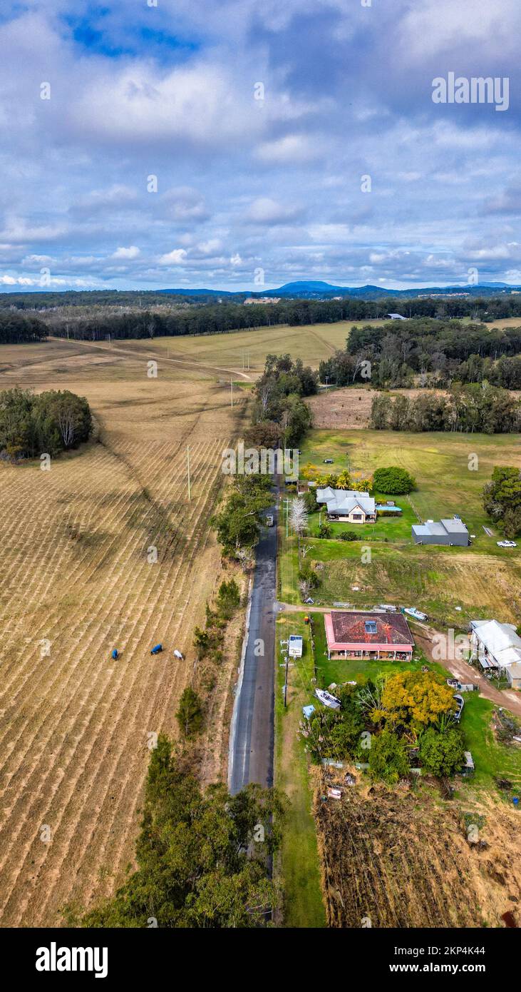 A vertical aerial view of the roadside fields and buildings in the ...