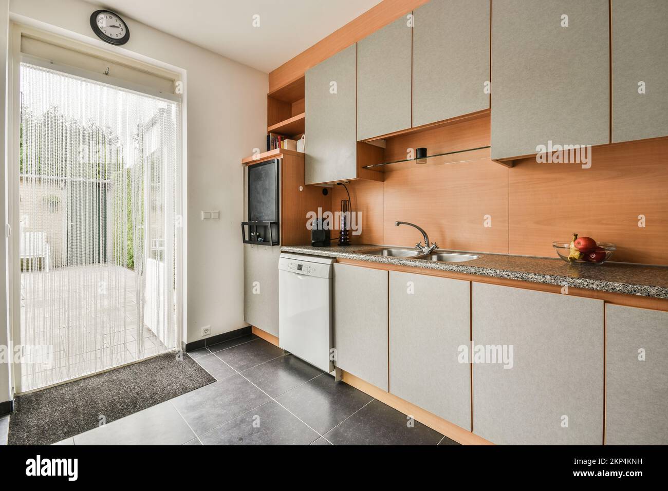 Table with chairs and flowers located near lounge area and kitchen in ...