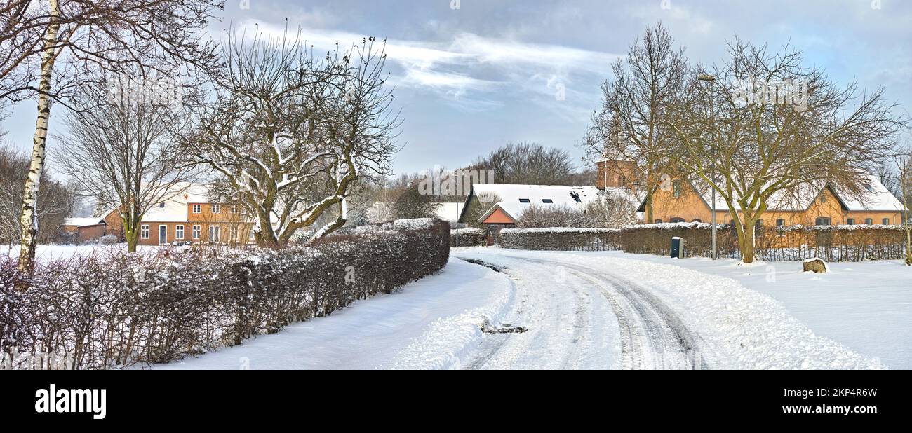 Wintertime in the village. A road running through a snowcapped town in ...
