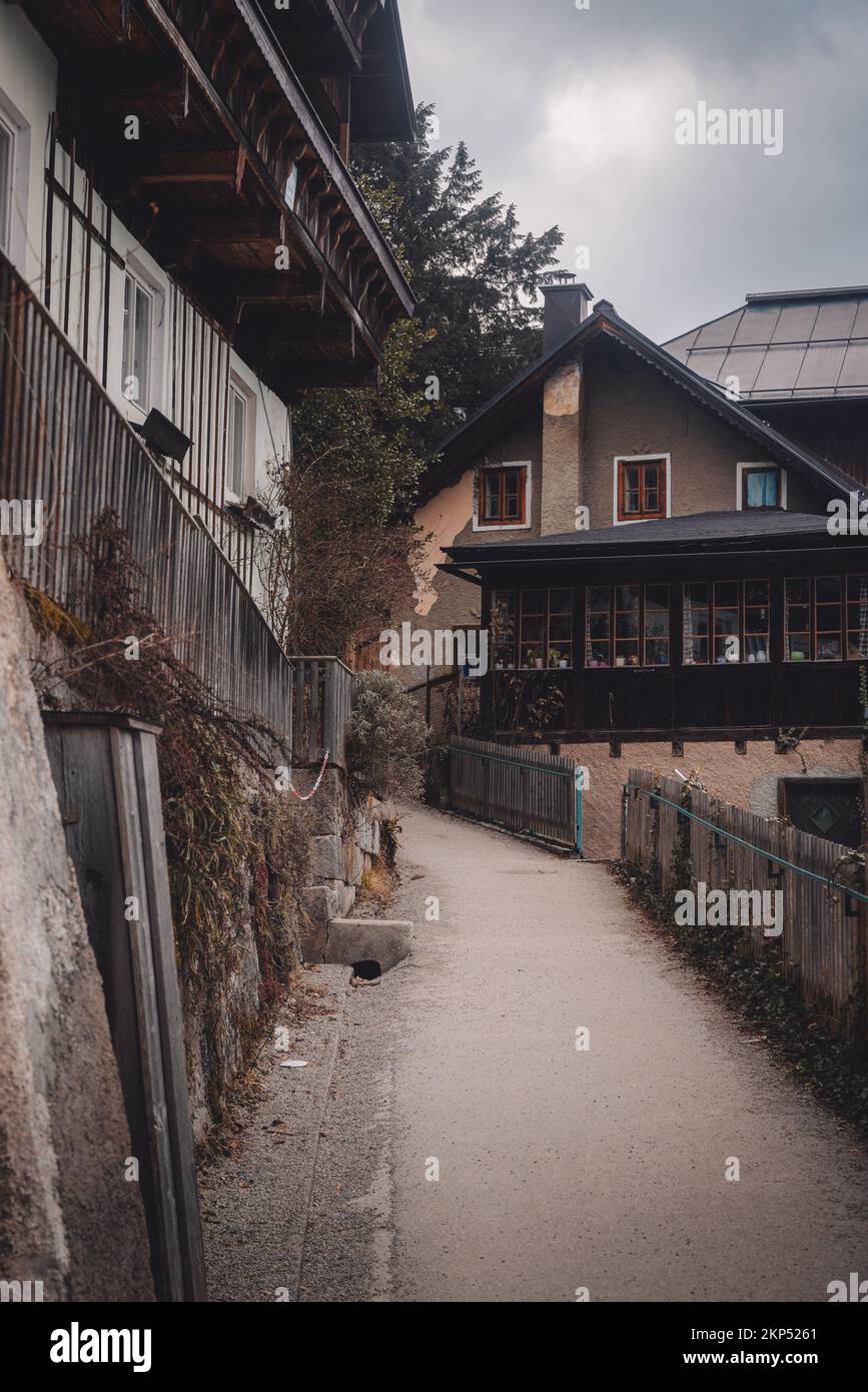 Rural traditional chalet in Hallstatt street in Austria under cloudy ...
