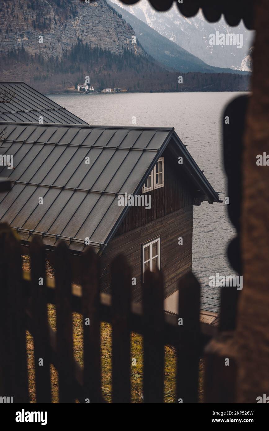 traditional chalets roofs with wooden fence by lake in Hallstatt street ...