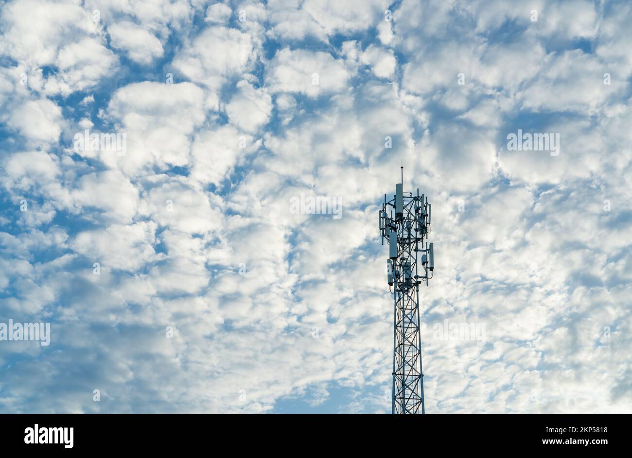 Telecommunication tower with blue sky and white clouds background ...