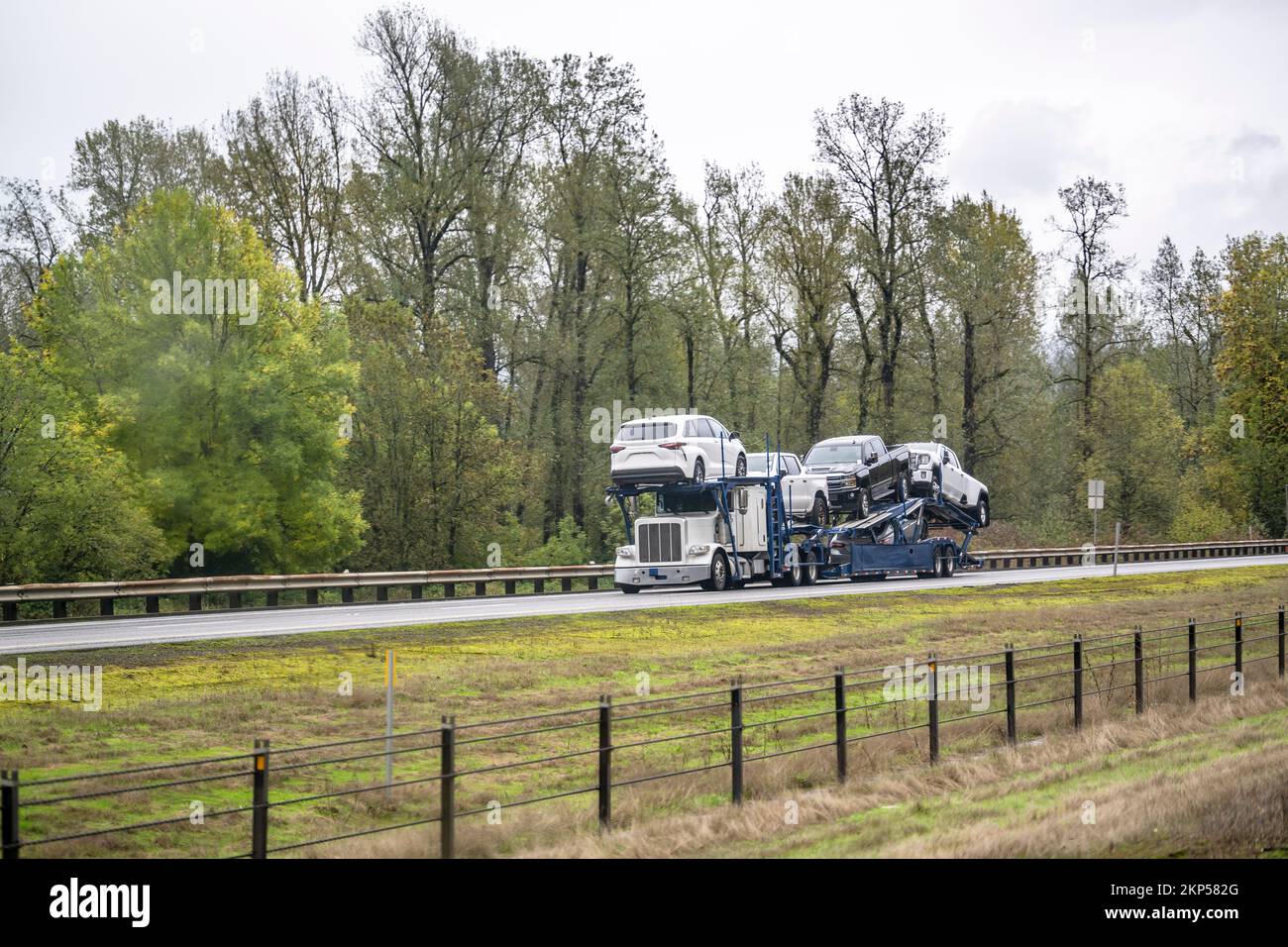 White commercial big rig car hauler semi truck with turned off ...
