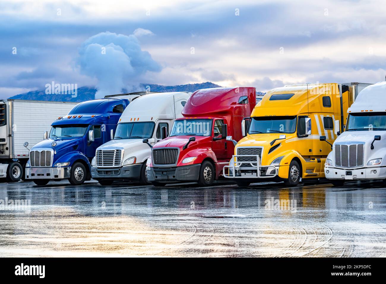 Different make big rigs semi trucks tractors with loaded semi trailers ...