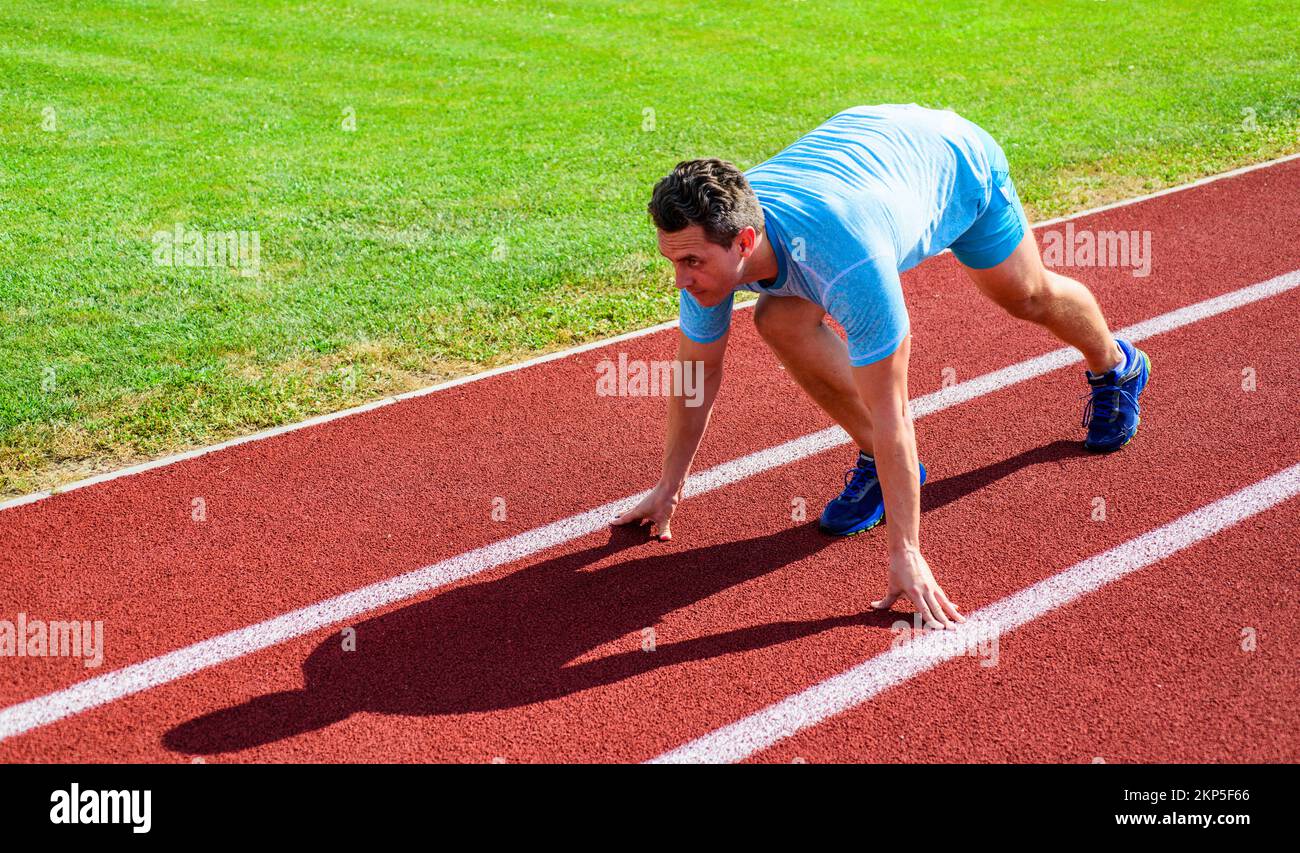 Sport tips from professional runner. Man athlete runner stand low start ...