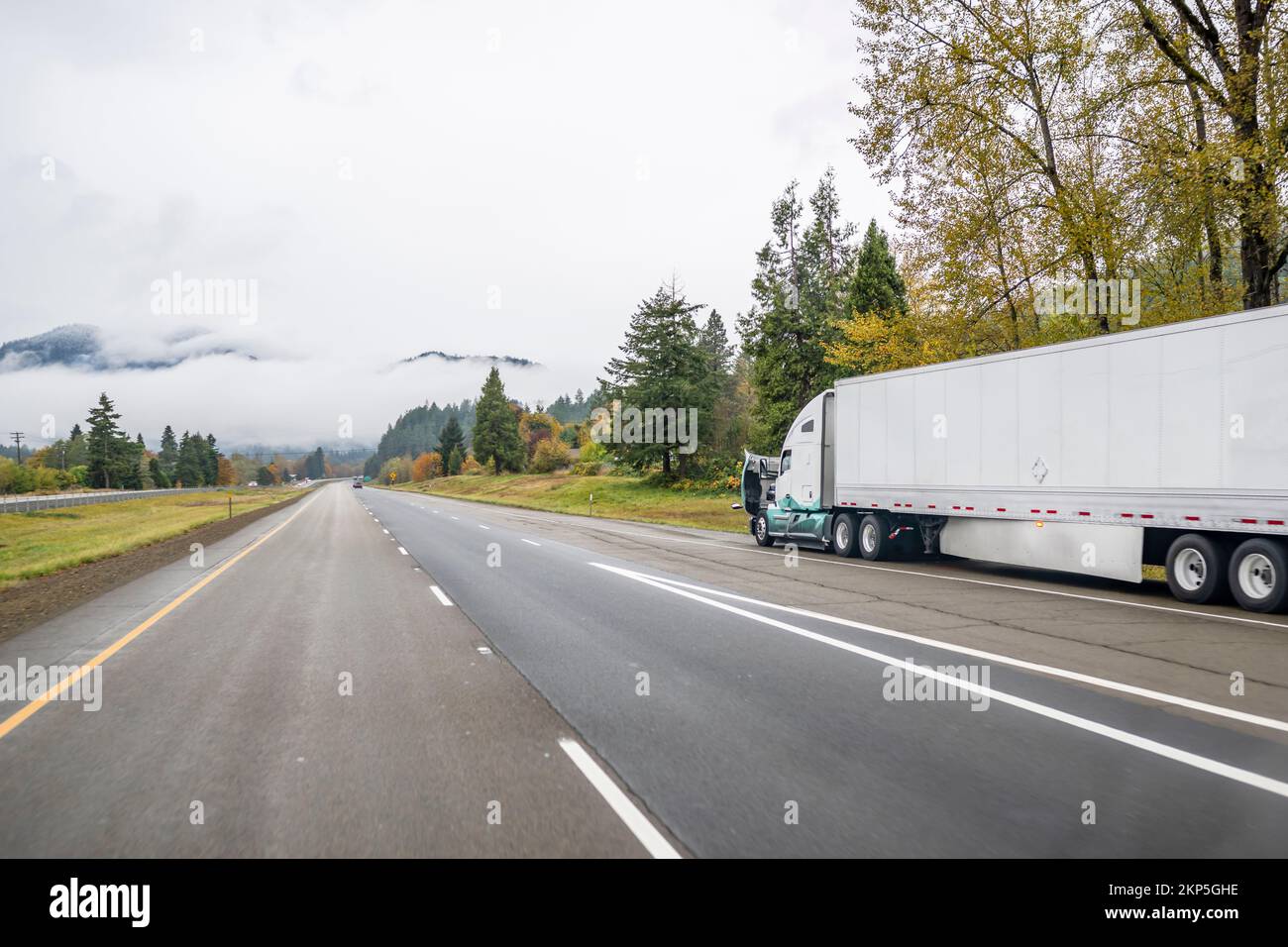 Broken big rig semi truck with open hood and semi trailer standing out ...