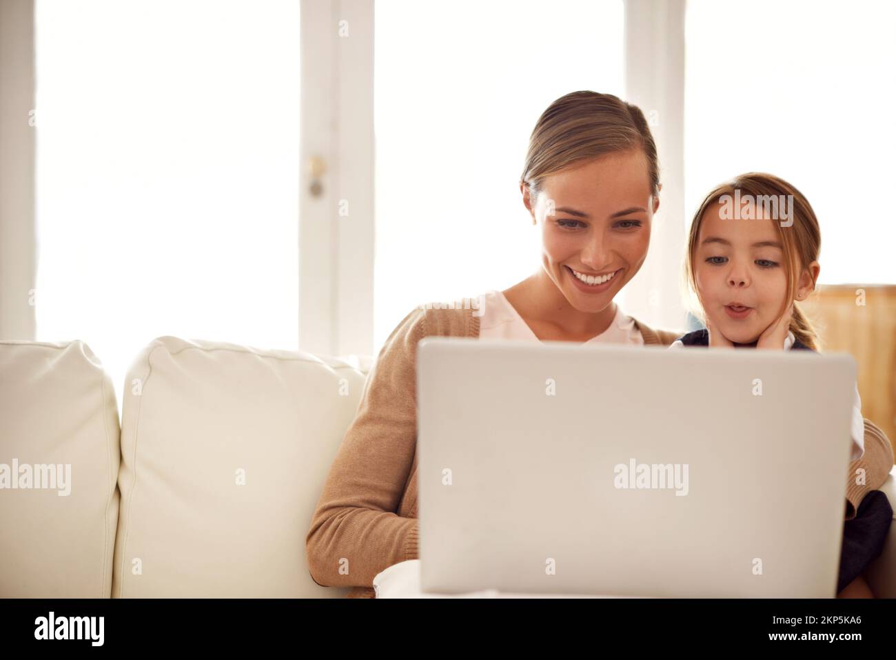 Teaching her internet safety. a mother using a laptop with her daughter ...