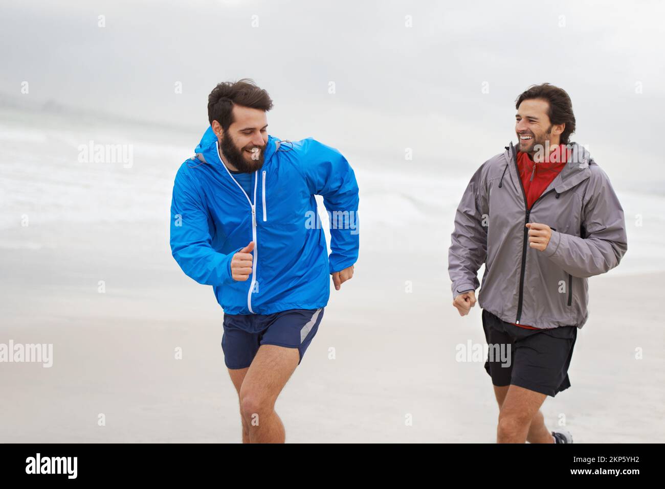 Two fit young men running on beach hi-res stock photography and images ...