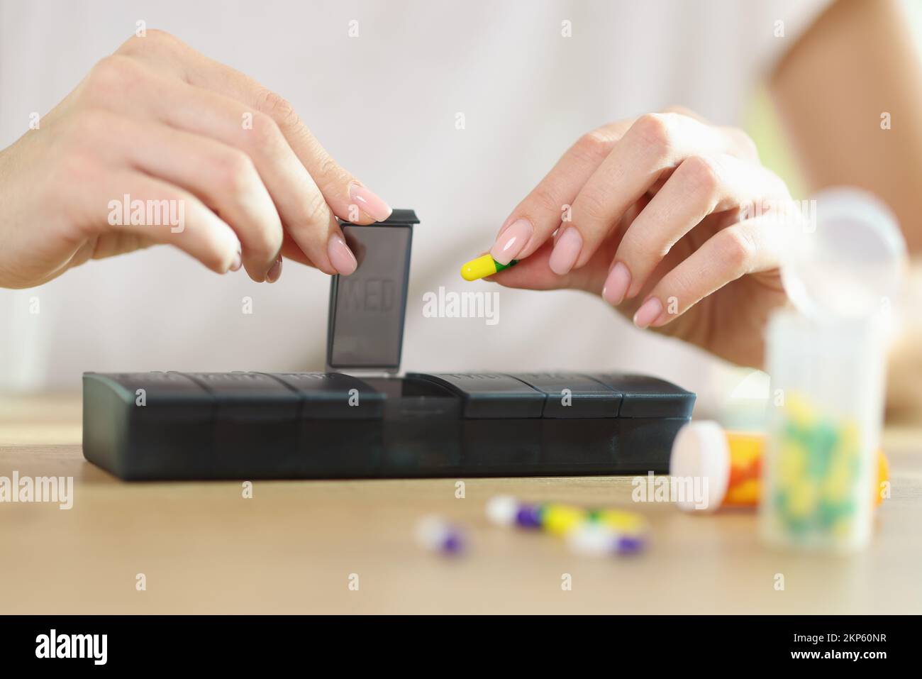 Female hands pouring tablets into medicine pill box closeup Stock Photo ...