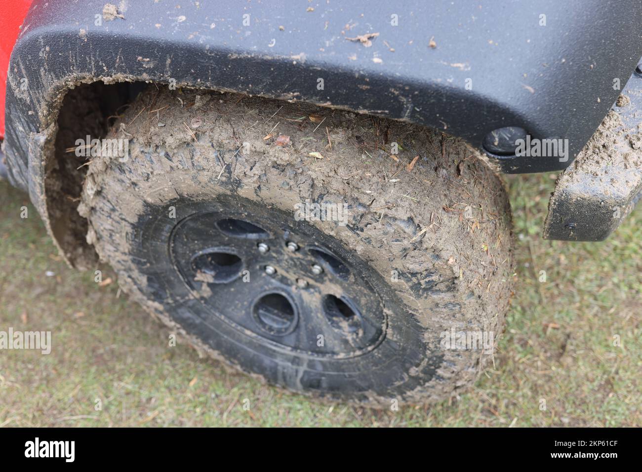 Red car wheel with dirty wheels standing on rural road closeup Stock ...