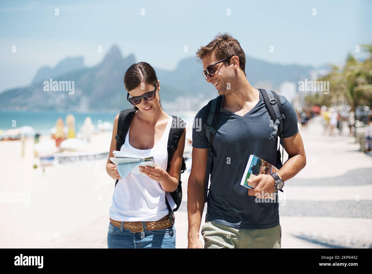 Better leave the directions to her. a young couple walking beside the ...