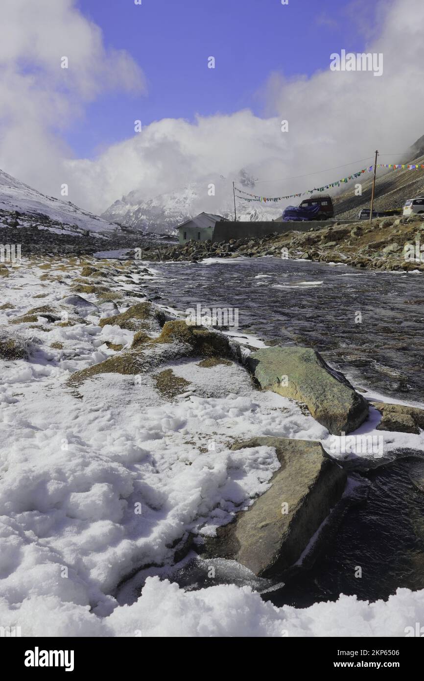 frozen mountain stream flowing through the scenic alpine valley at ...
