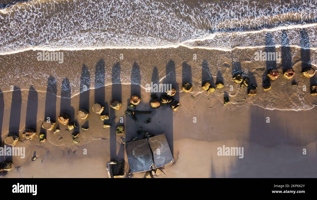An aerial view of a ruined WW2 bunker on Fraisthorpe Beach in sunny ...
