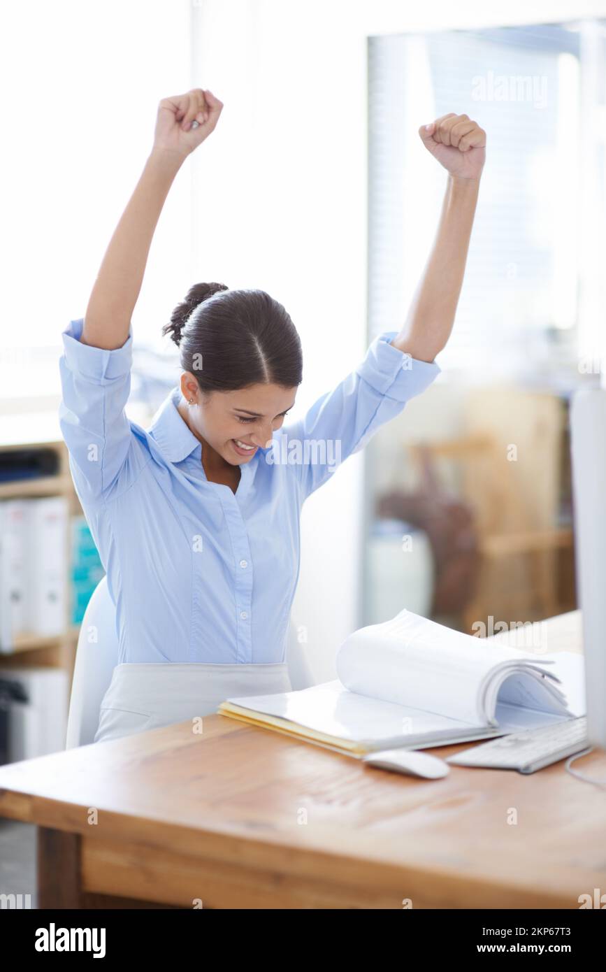 My hard work paid off. A young businesswoman celebrating a victory ...