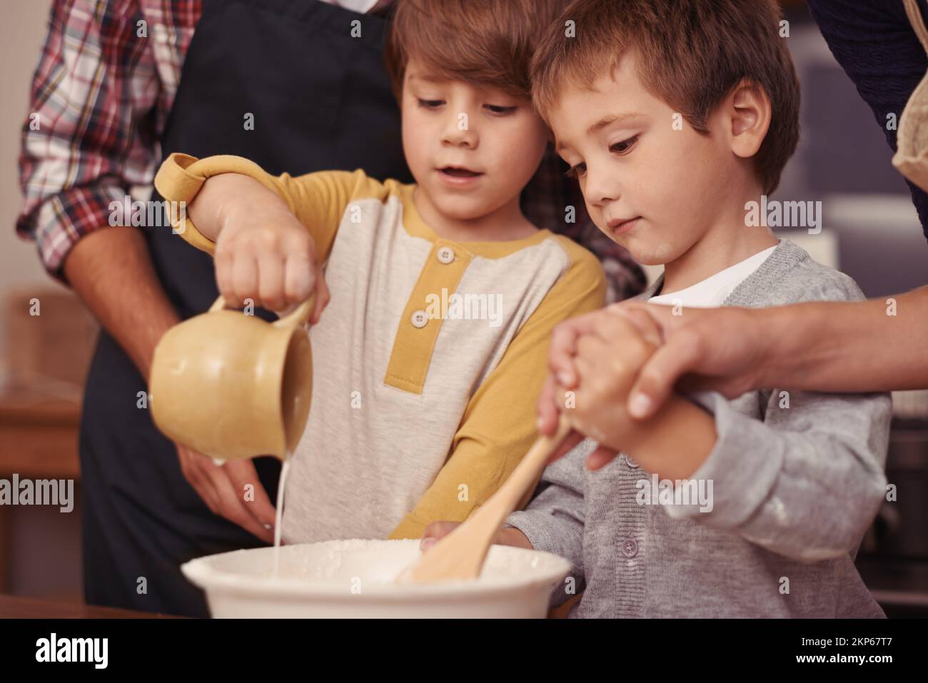 Look at how great Im doing. two young brothers baking in the kitchen ...