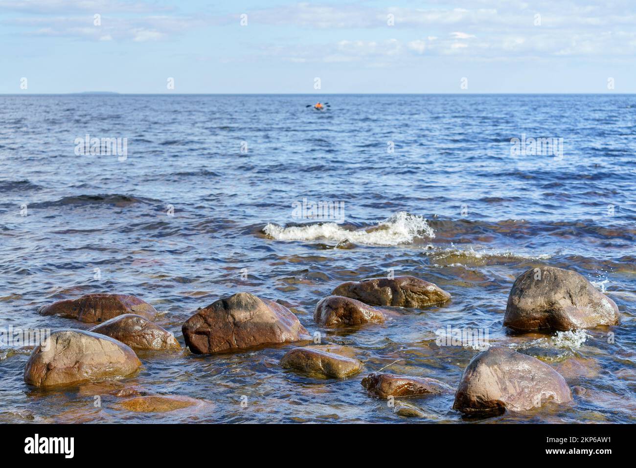 A scenic view of a landscape with beautiful stones on the lake in ...