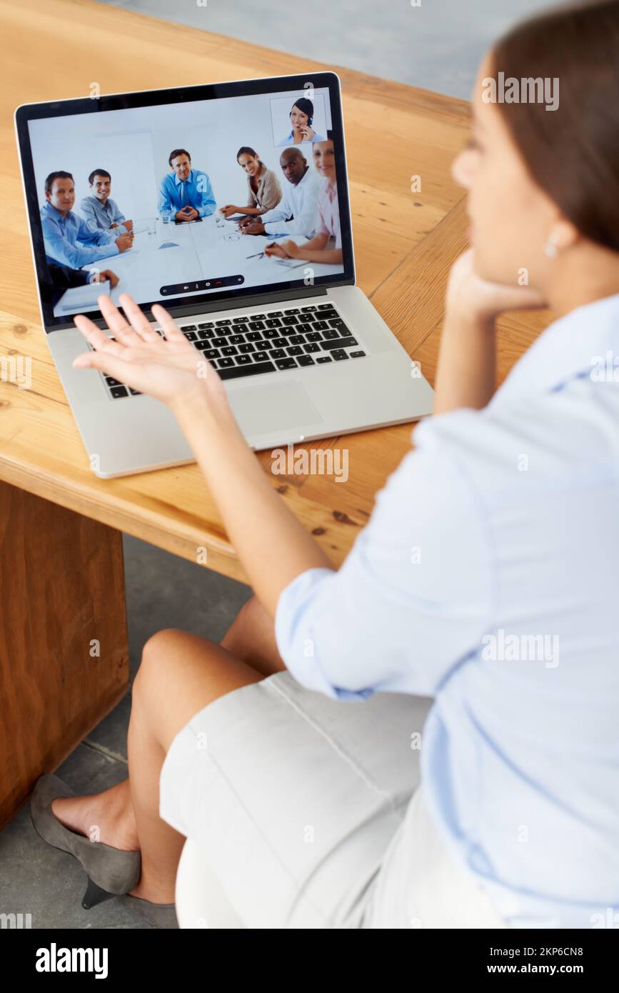 Video conferencing makes business so convenient. a young businesswoman ...