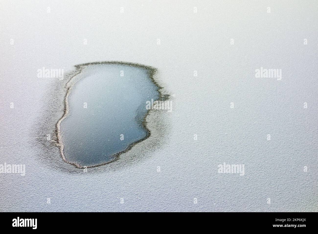 Melted water puddle on the lake Stock Photo - Alamy