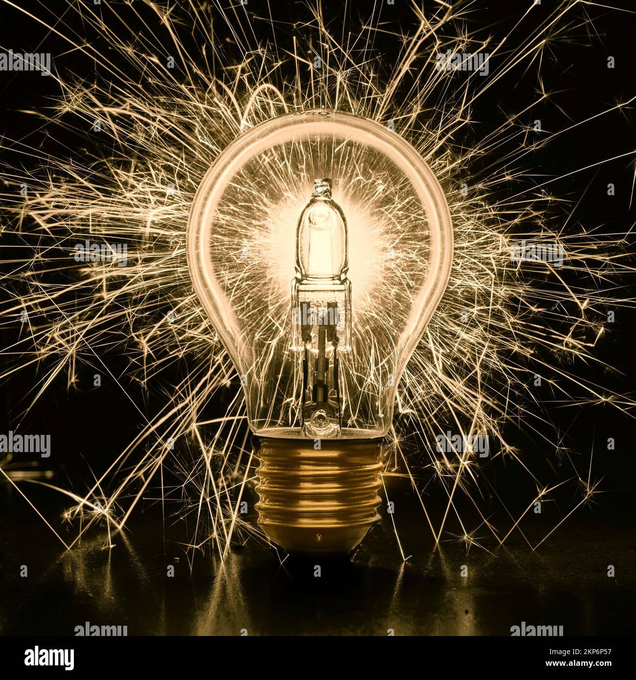 A Light bulb with golden sparkles on black background Stock Photo - Alamy