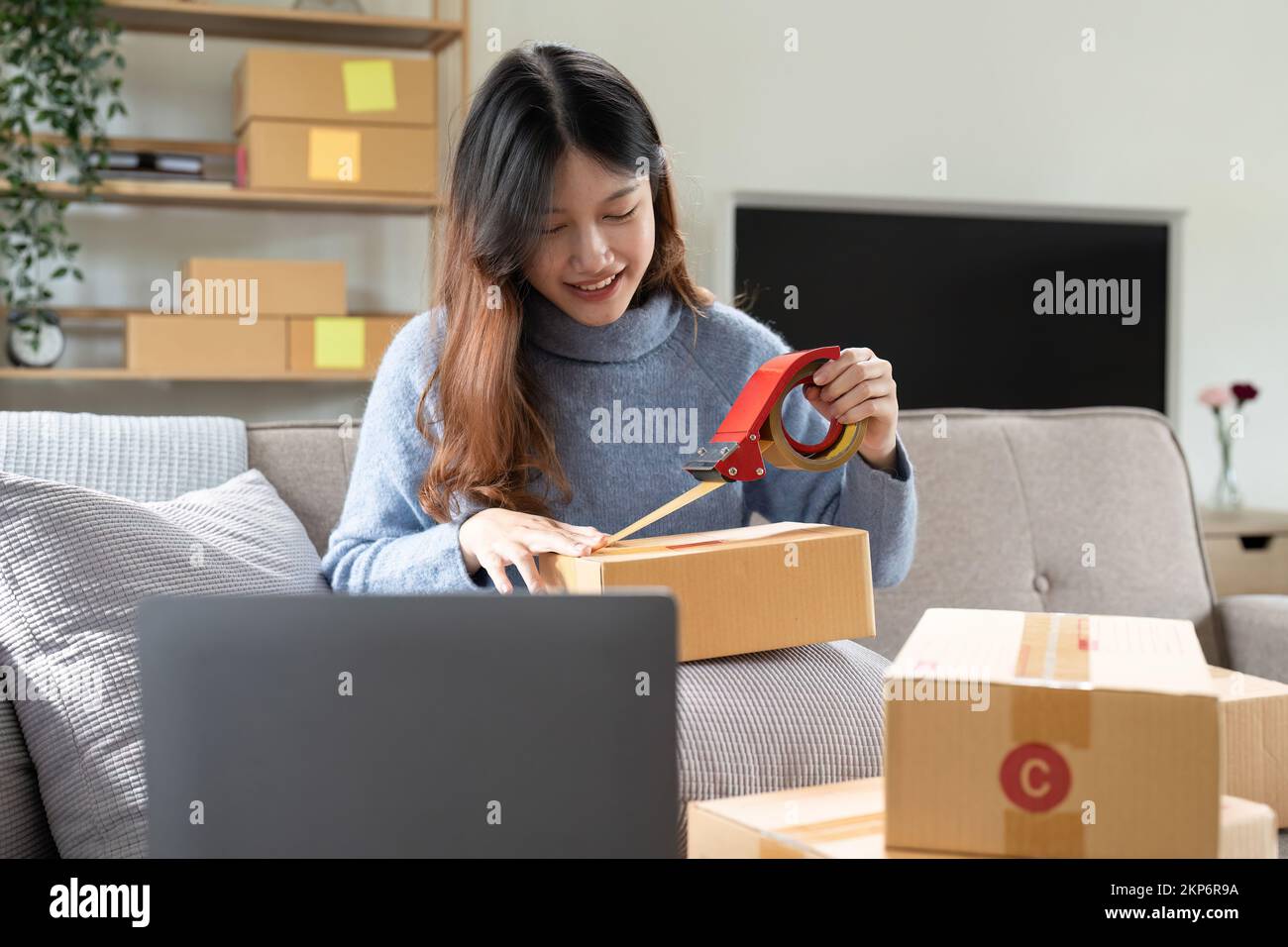 Startup small business, Young woman working freelance and packing box ...