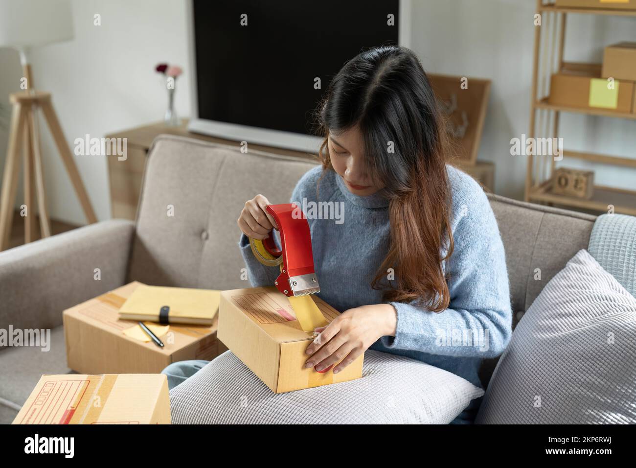 Startup small business, Young woman working freelance and packing box ...