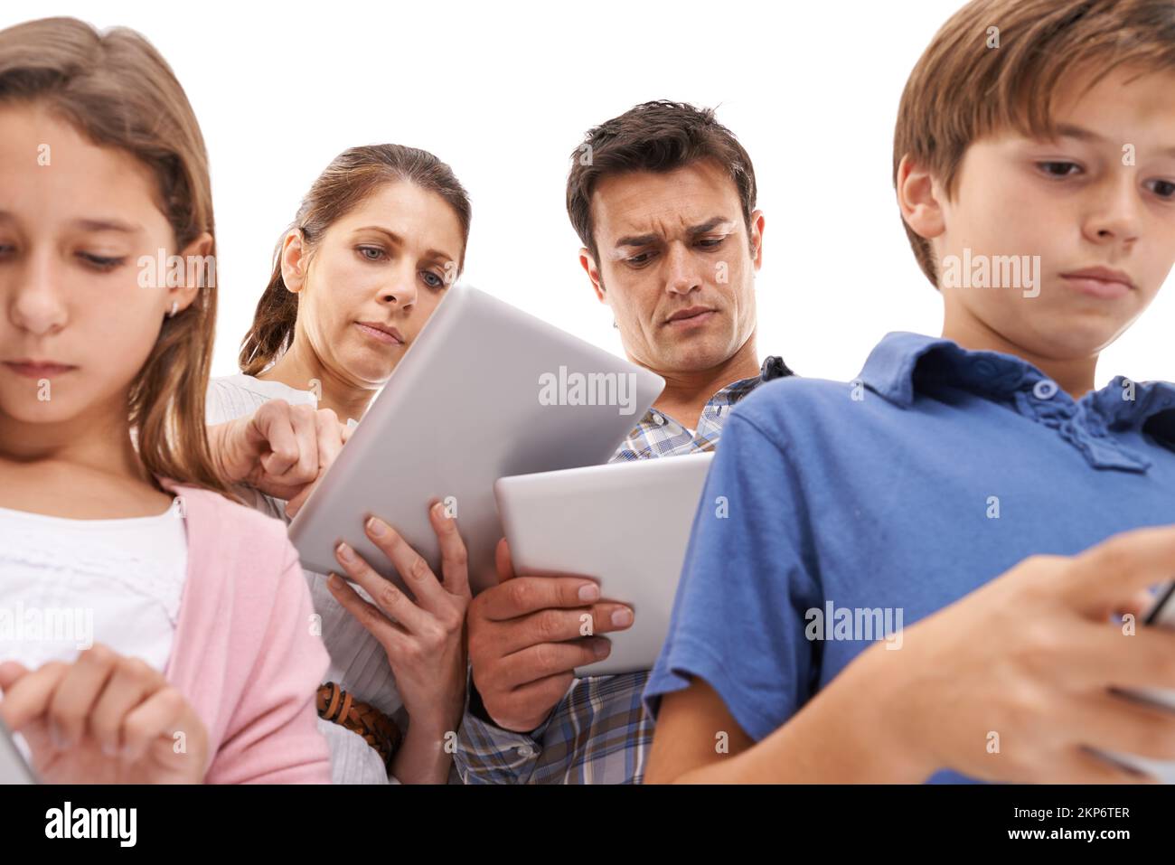 Wrapped up in the online world. A family of four all using digital ...