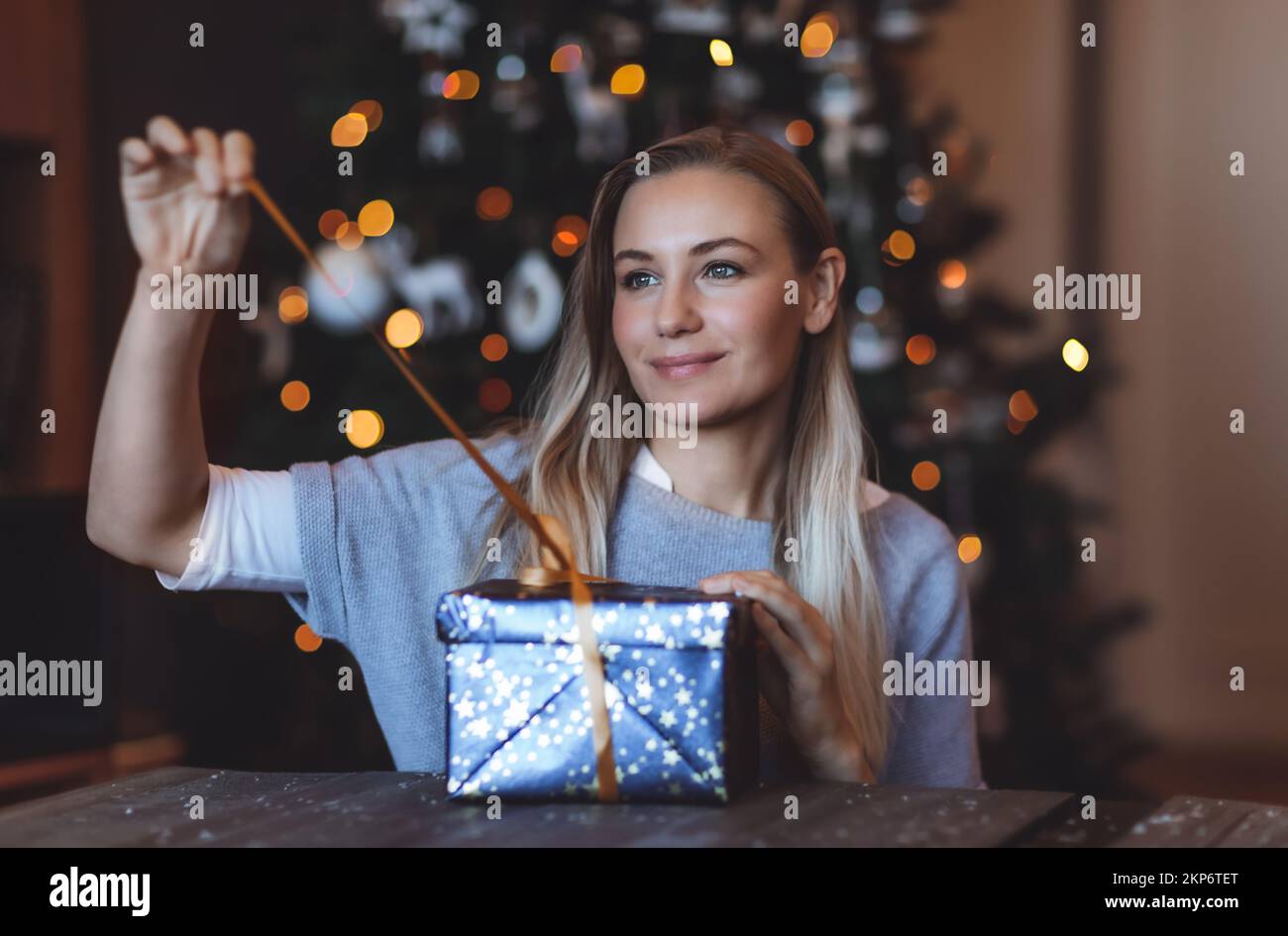 Woman opens new year gift hi-res stock photography and images - Alamy