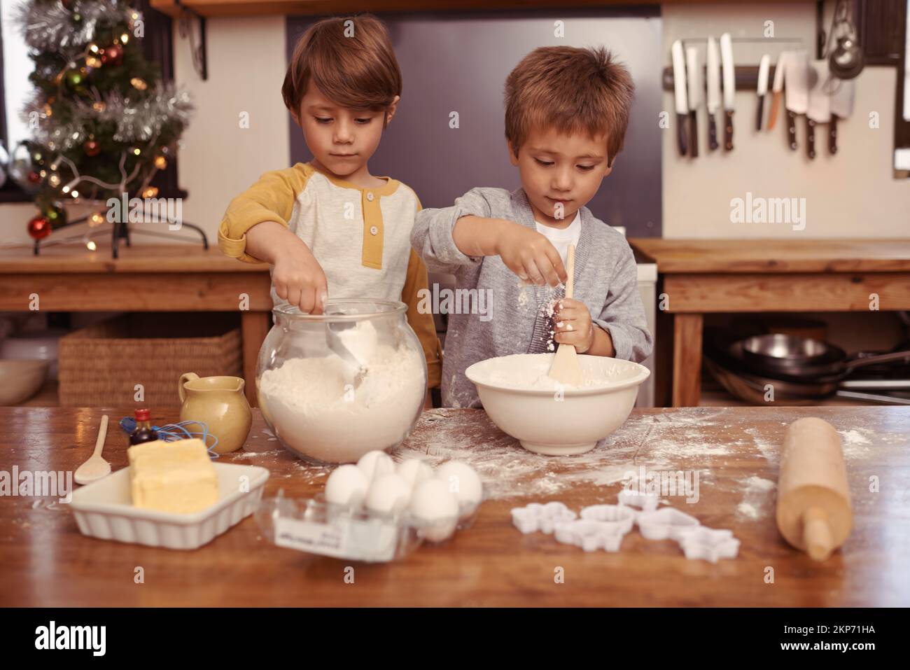 Focused on their baking. two young brothers baking in the kitchen Stock ...