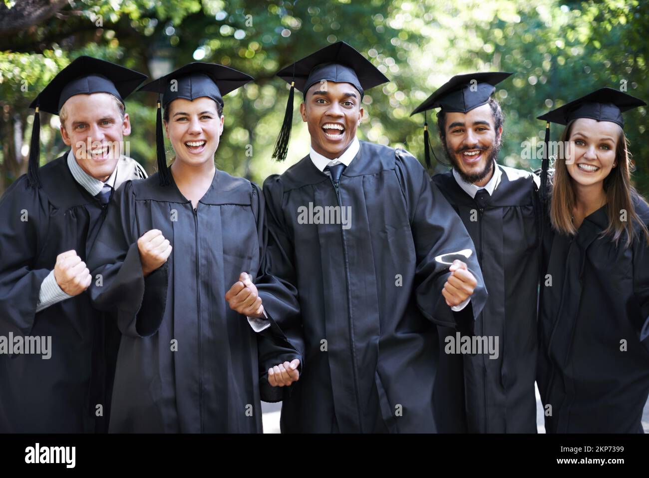 Theyre proud graduates. A group of happy students punching the air in ...