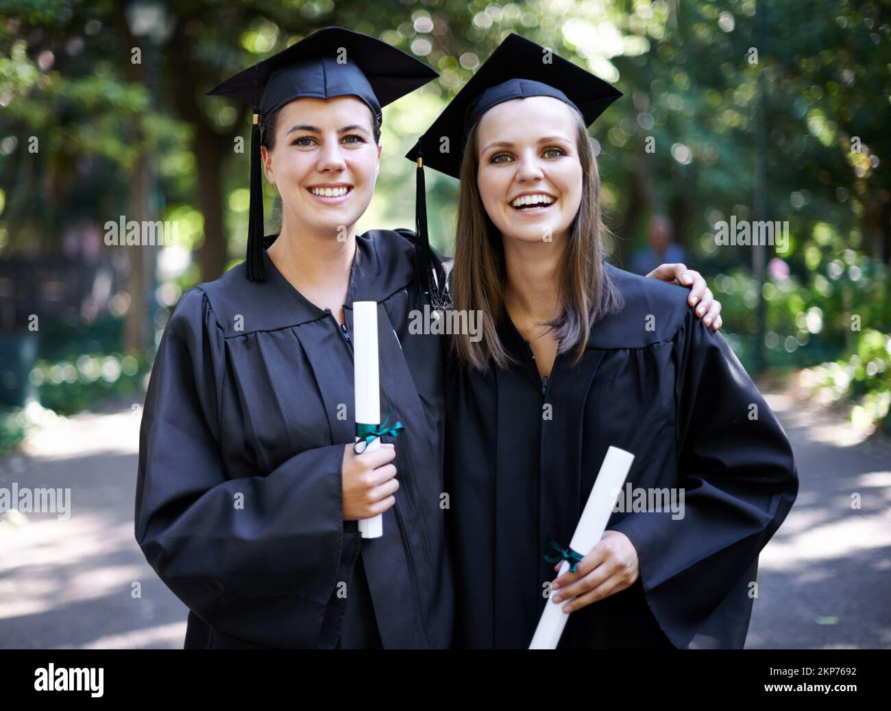 Theyre proud graduates. A portrait of two female students holding their ...