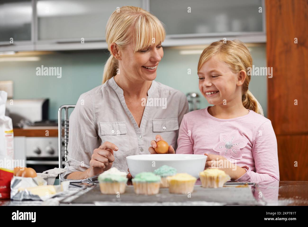 Learning and loving. an attractive young woman baking with her adorable ...