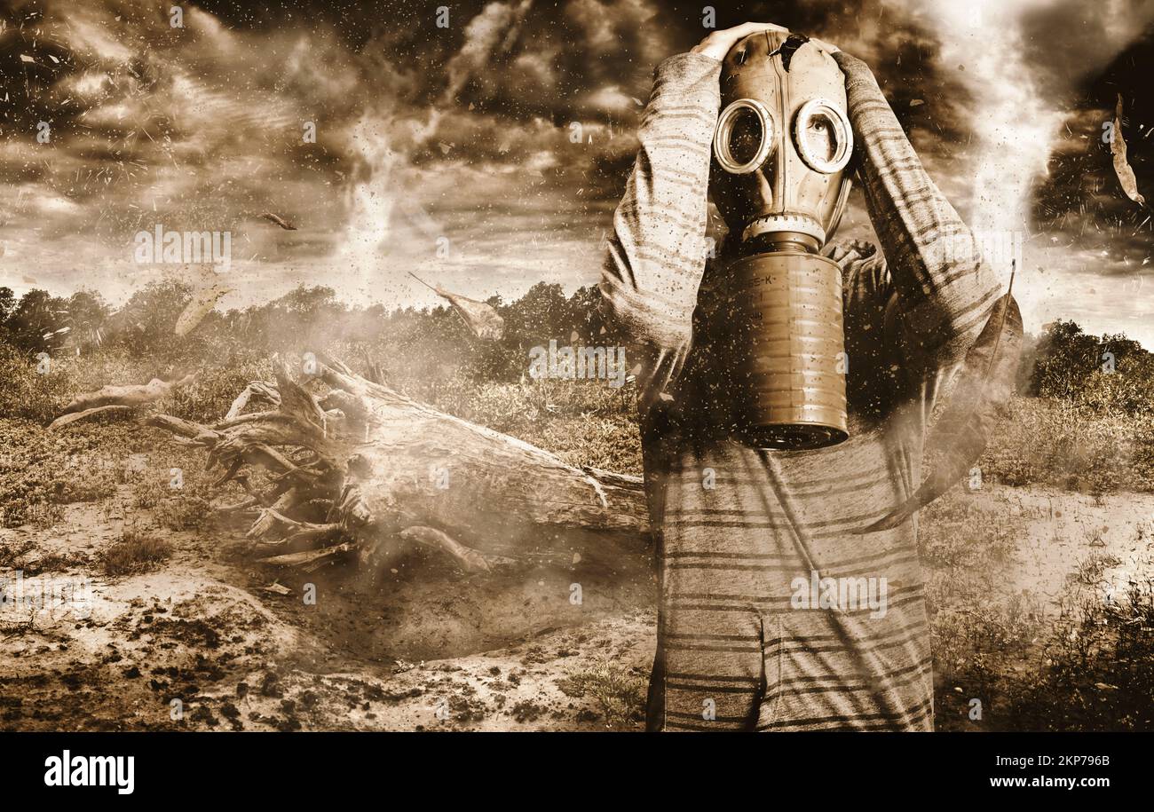 Creative portrait of a weary man standing in a baron wasteland wearing ...