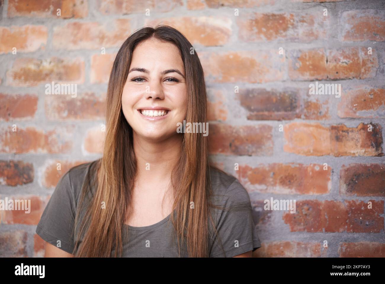 Woman standing against brick loft hi-res stock photography and images ...