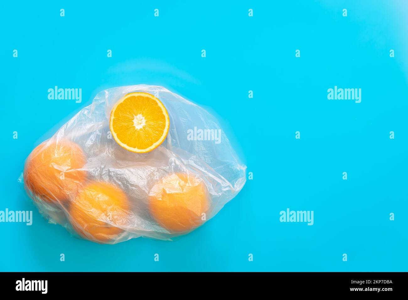 Oranges in plastic bag isolated on blue, flat lay Stock Photo - Alamy
