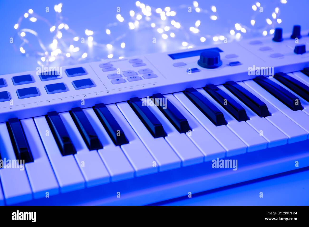 Musical keys and a garland on a blurred background with neon lighting ...