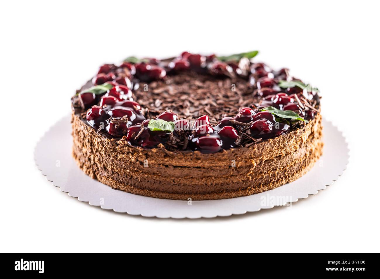 Chocolate cherry cake decorated with mint leaves on an isolated white ...