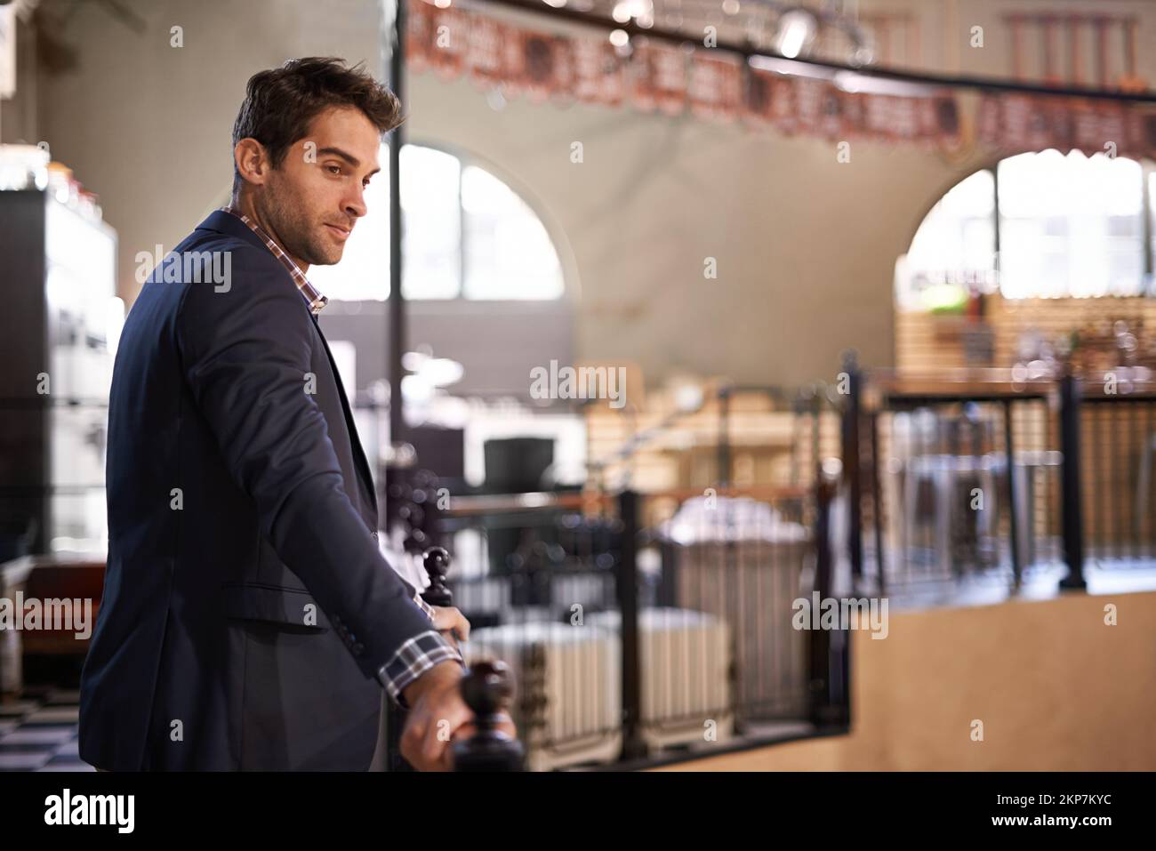 Getting my daily dose of coffee. a young man sitting in a coffee shop ...