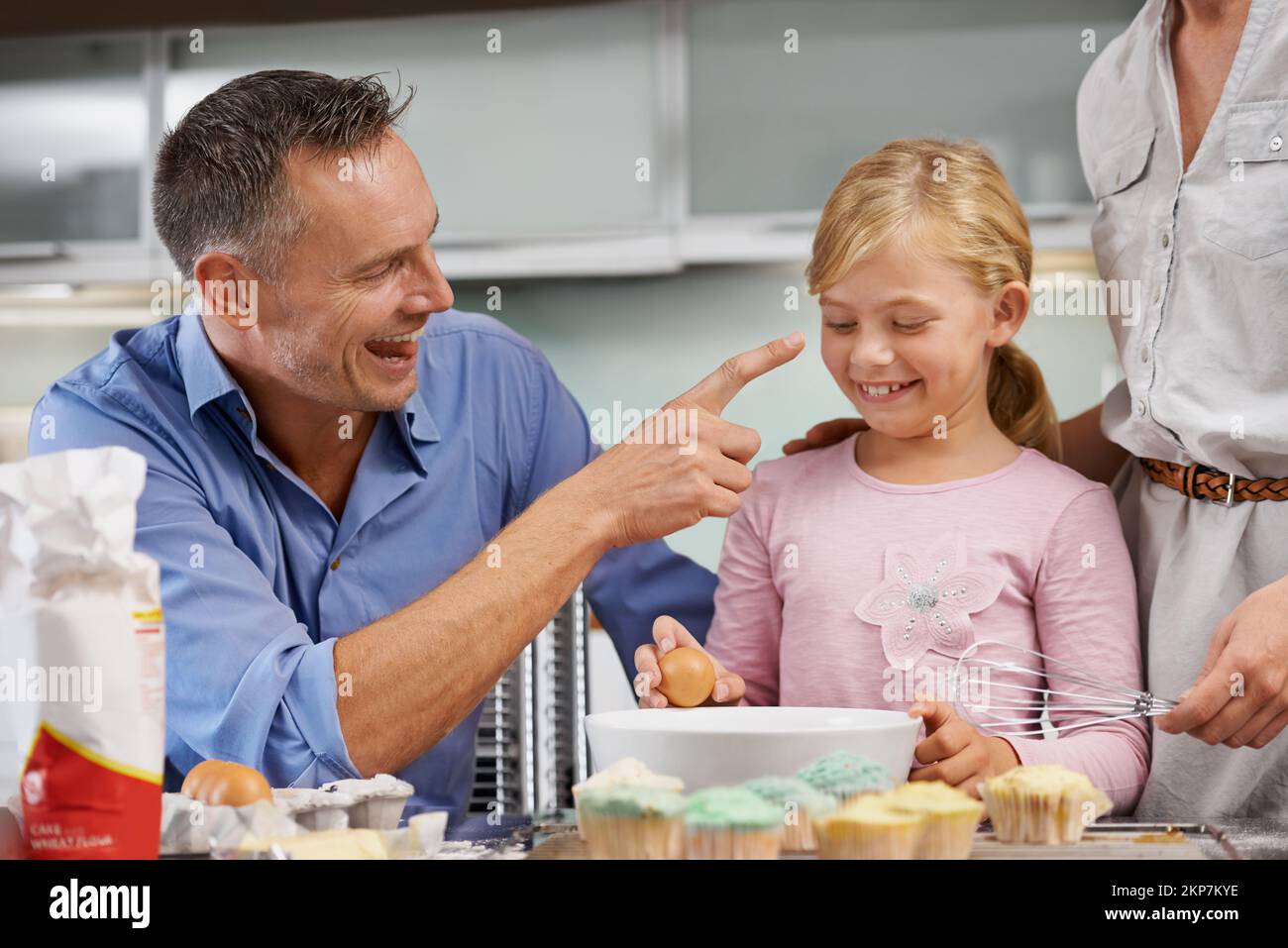 Mess is half the fun. a family baking together and laughing Stock Photo ...