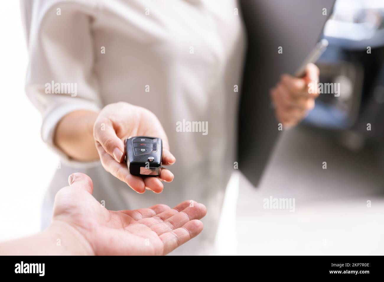 A woman's hand signing a car loan contract agreement Stock Photo - Alamy