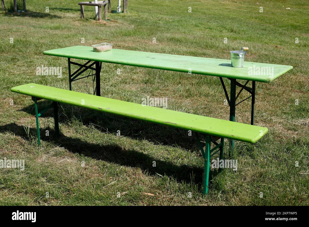 Green wooden benches and folding tables on a meadow, Germany Stock ...