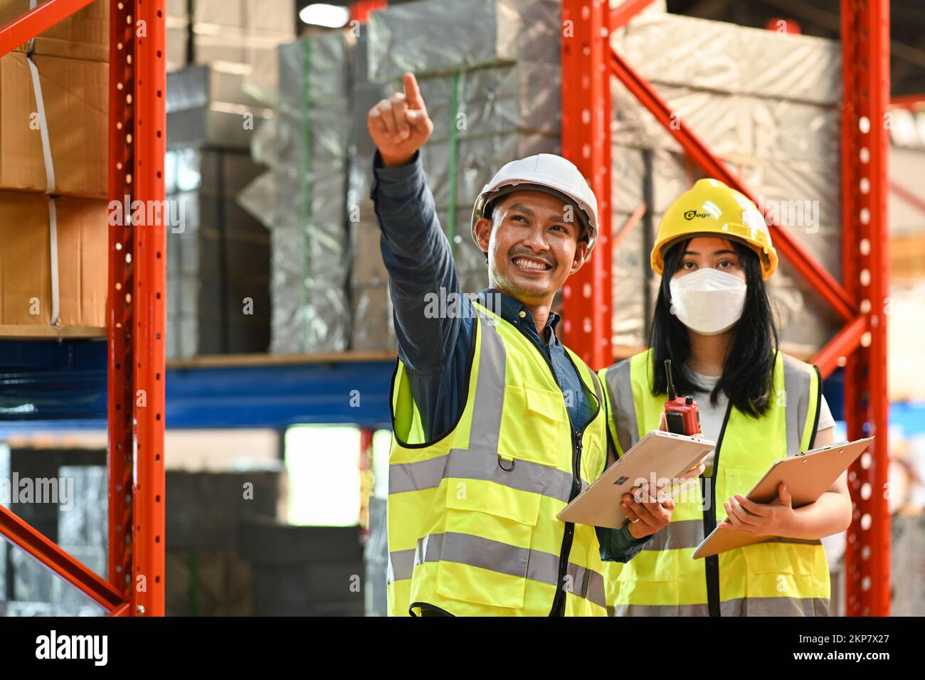 Image of male and female workers wearing hardhats and reflective jacket ...