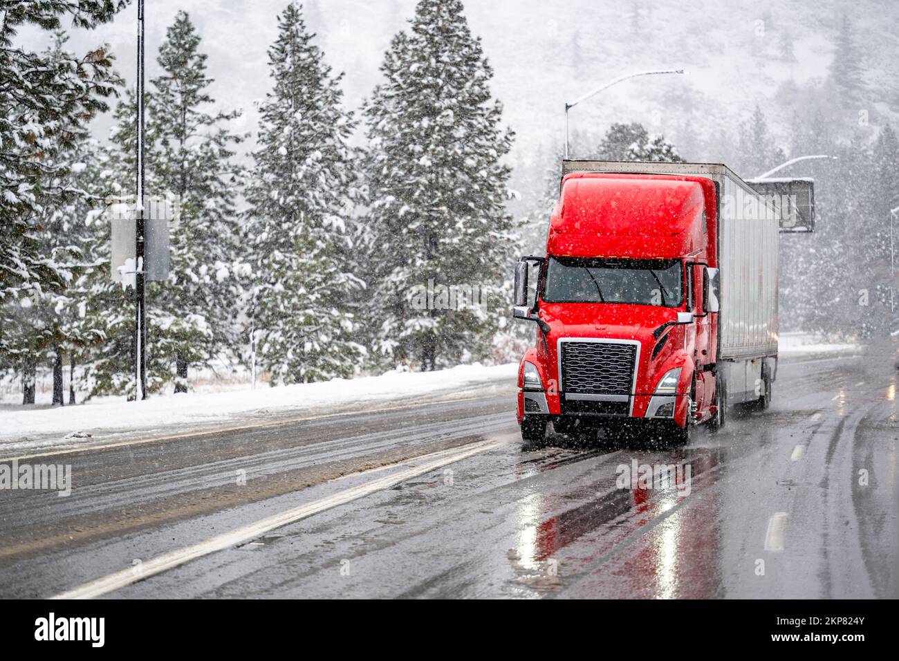 Red big rig commercial semi truck transporting cargo in dry van semi ...