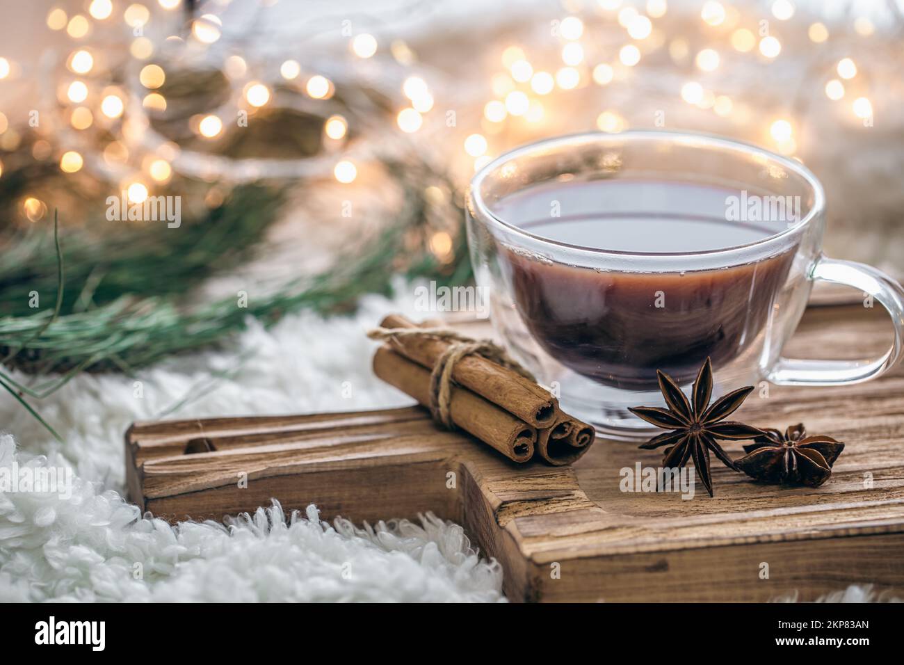 A cup of cocoa, cinnamon and star anise on a blurred background with ...