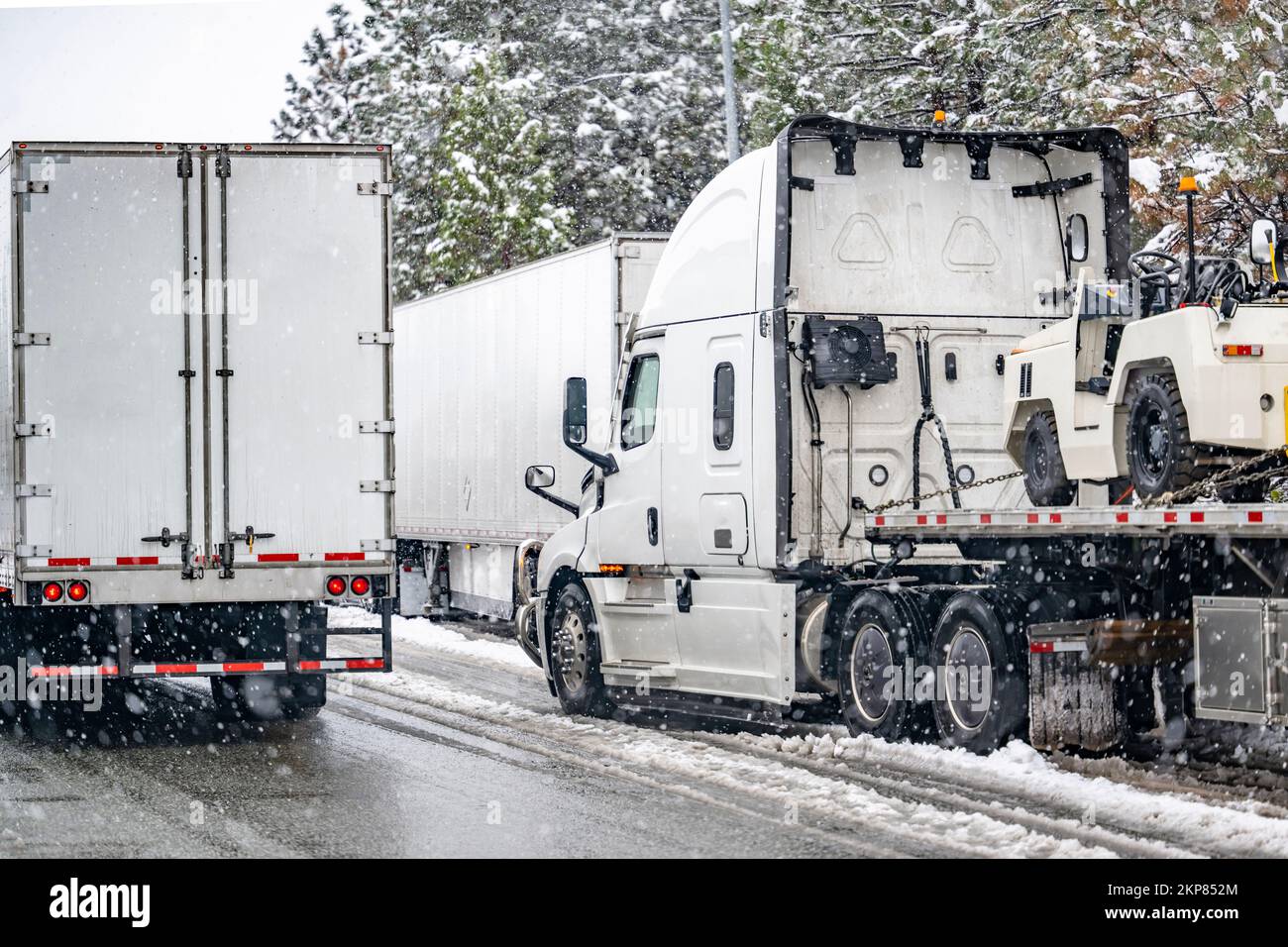 Convoy of industrial big rigs semi trucks with semi trailers ...