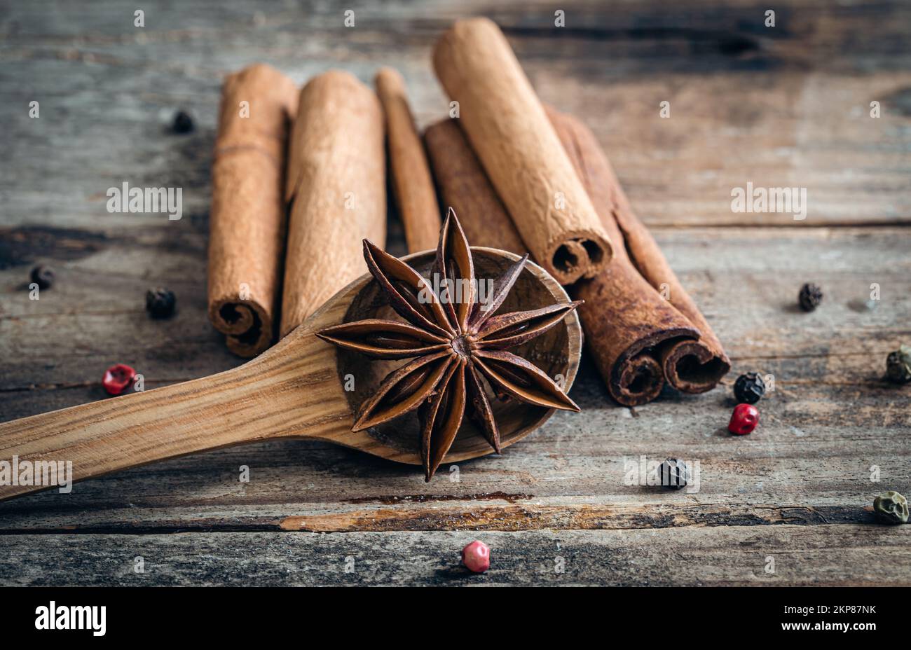 Composition with star anise and cinnamon sticks on a wooden background ...