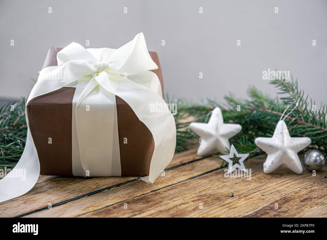 Gift box, decorative details and spruce branches on a blurred ...