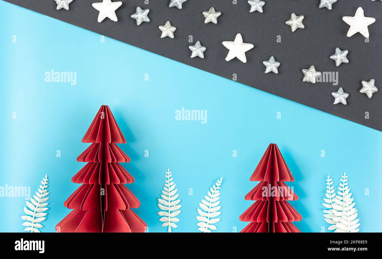 Two origami paper Christmas trees on a paper background, flat lay Stock ...